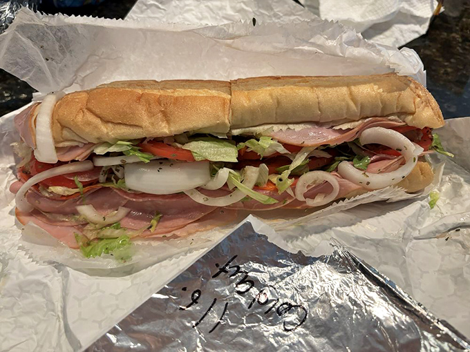 The Italian cold cut sub stands tall and proud, a colorful architecture of meats, veggies, and bread that demands to be admired before devoured.
