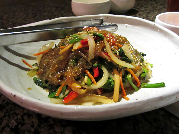 Japchae: where sweet potato noodles tango with vegetables in a sesame-soy glaze. It's the side dish that frequently steals the spotlight.