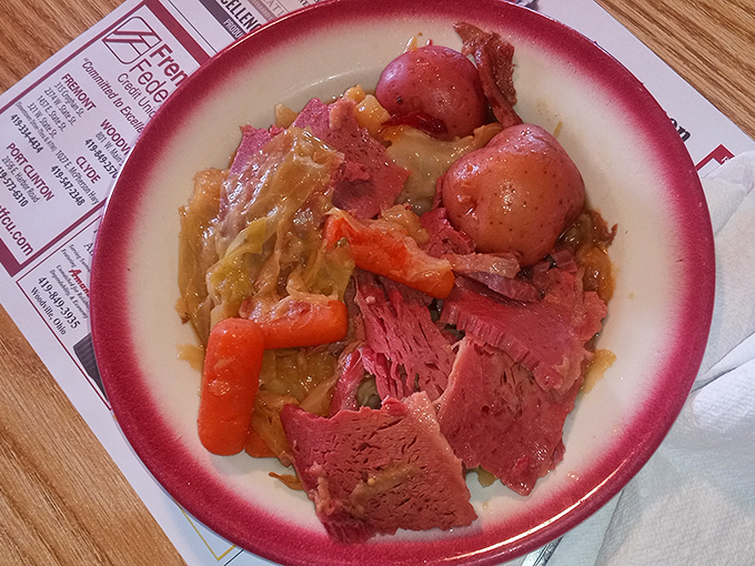 The Jiggs Dinner showcases tender corned beef alongside potatoes and vegetables. This isn't just a meal; it's a cultural touchstone served on a rimmed plate.