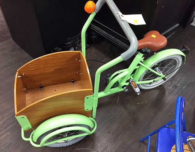 This lime-green cargo tricycle isn't just transportation&mdash;it's childhood joy on wheels, ready for its next adventure with a lucky kid.