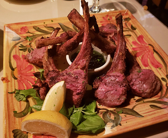 Lamb chops presented like the crown jewels they are &ndash; perfectly pink, expertly seasoned, and arranged with the precision of Renaissance art.