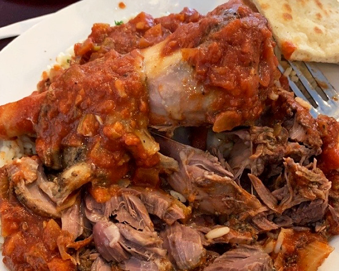 This lamb shank isn't just falling off the bone&mdash;it's practically filing for independence, swimming in a rich tomato sauce worth bottling.