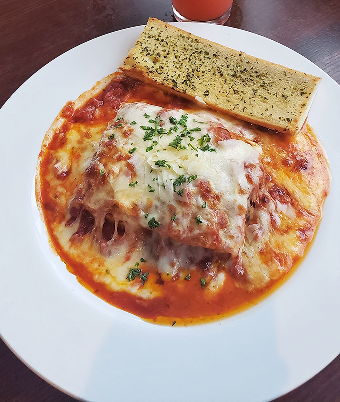 Lasagna that doesn't know when to quit, with layers upon layers of pasta, cheese, and sauce. That garlic bread isn't just a side &ndash; it's essential equipment.