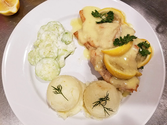 Chicken bathed in lemony sauce with perfectly formed mashed potatoes&mdash;proof that Polish cuisine isn't all about heaviness, but balance and brightness too.