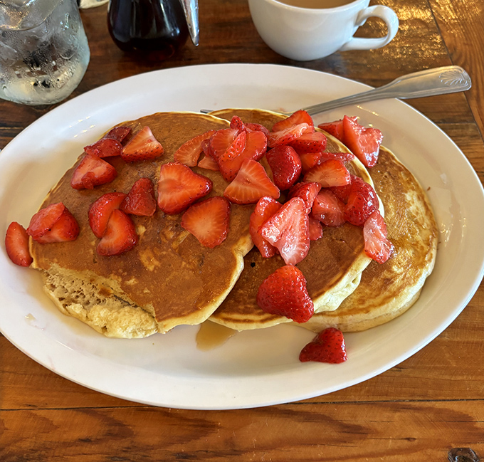 Lemon ricotta pancakes crowned with strawberries turn ordinary mornings into something worthy of Sunday brunch royalty.