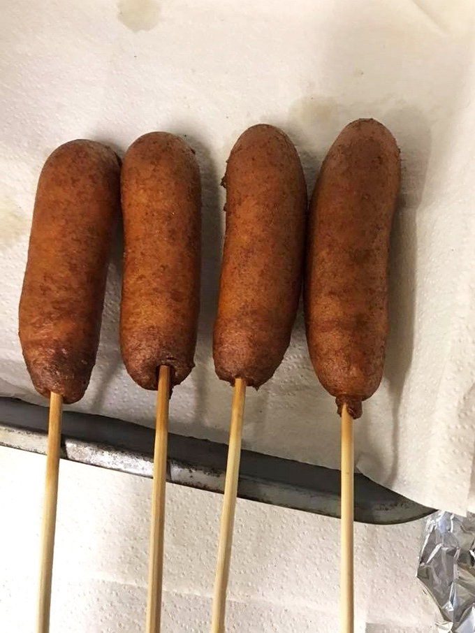 Carnival food that demands both napkins and devotion&mdash;these corn dogs represent the universal truth that anything on a stick tastes better at a flea market.