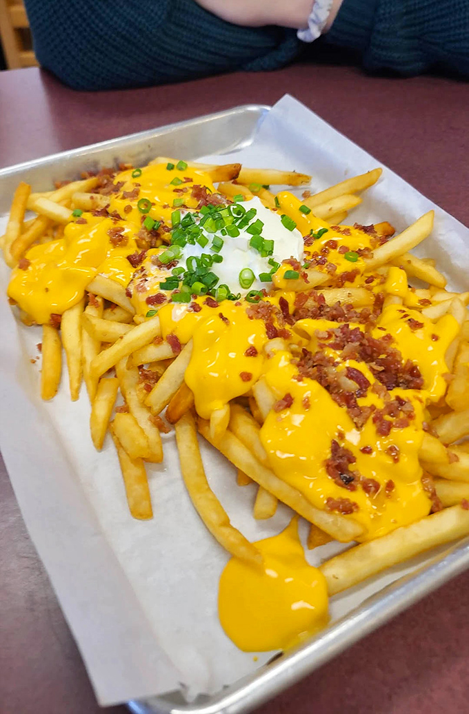 The "Whatever Fries" in their full glory&mdash;a mountain of potatoes buried under cheese, bacon bits, and green onions. Diet plans come here to die gloriously.
