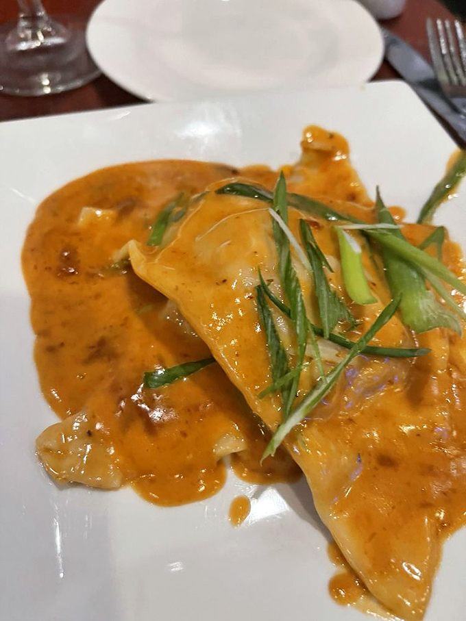 Golden lobster ravioli swimming in rich sauce delivers restaurant-quality elegance without the stuffy pretense.