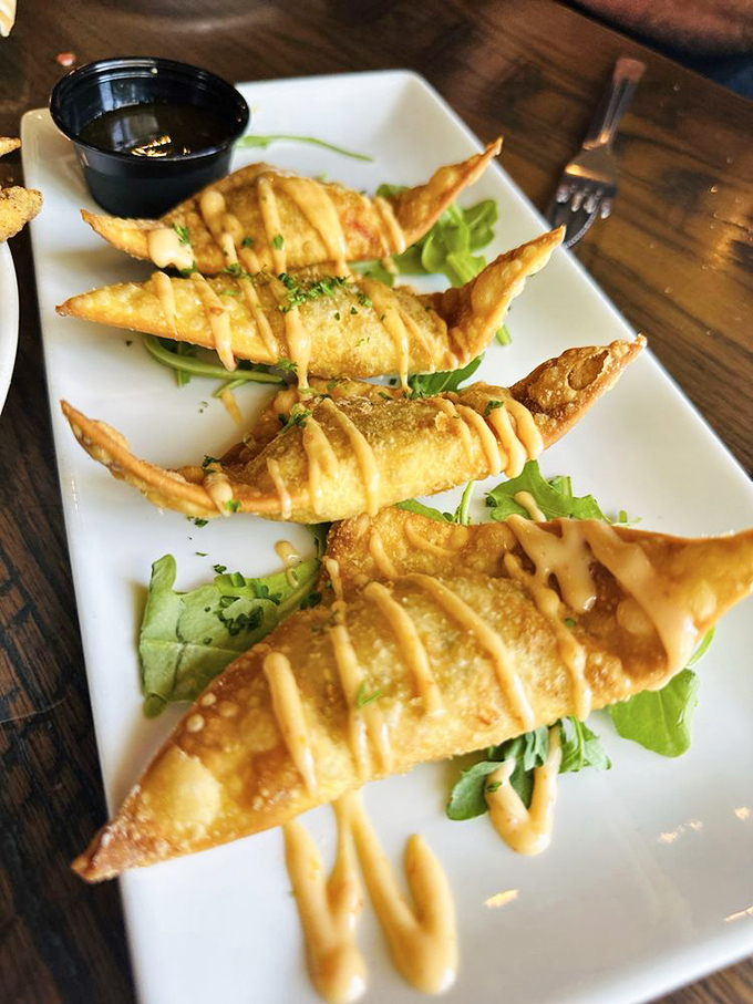 Golden lobster wontons that look like edible origami and taste like tiny parcels of coastal heaven on every bite.