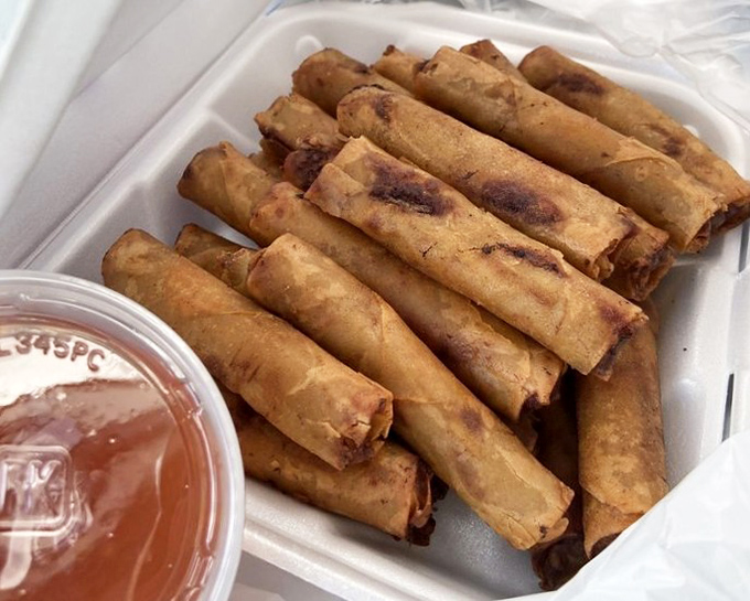 Crispy, golden lumpia lined up like delicious soldiers, ready to be dipped in that sweet-tangy sauce that completes the perfect bite. 