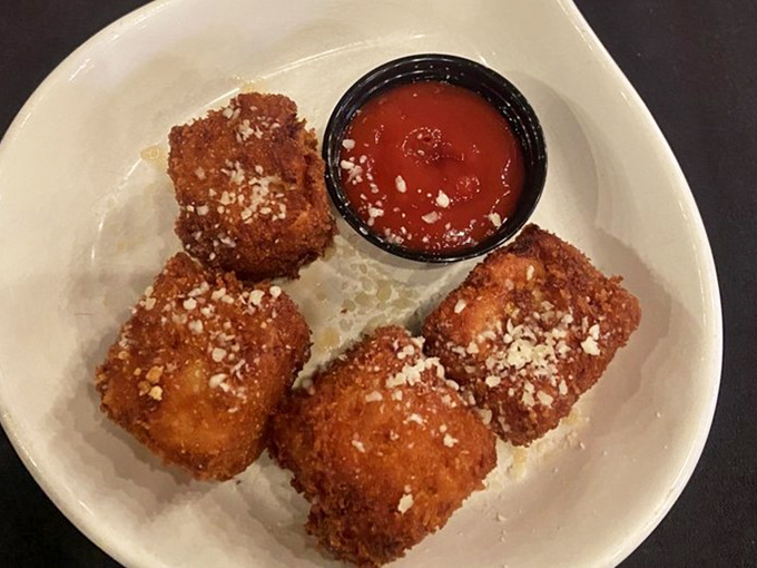 Mac and cheese that couldn't decide whether to be an appetizer or dessert, so it became art&mdash;crispy-coated cubes of comfort dusted with parmesan.
