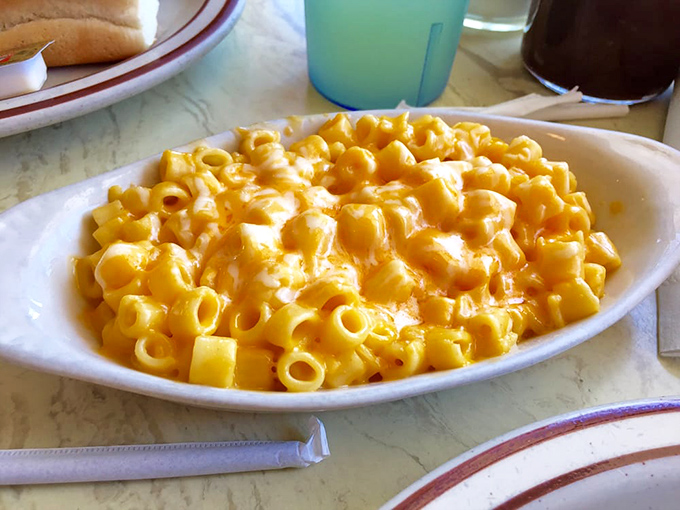 Mac and cheese so gloriously yellow and creamy it could make a grown adult weep. This isn't just comfort food—it's a warm hug for your taste buds.