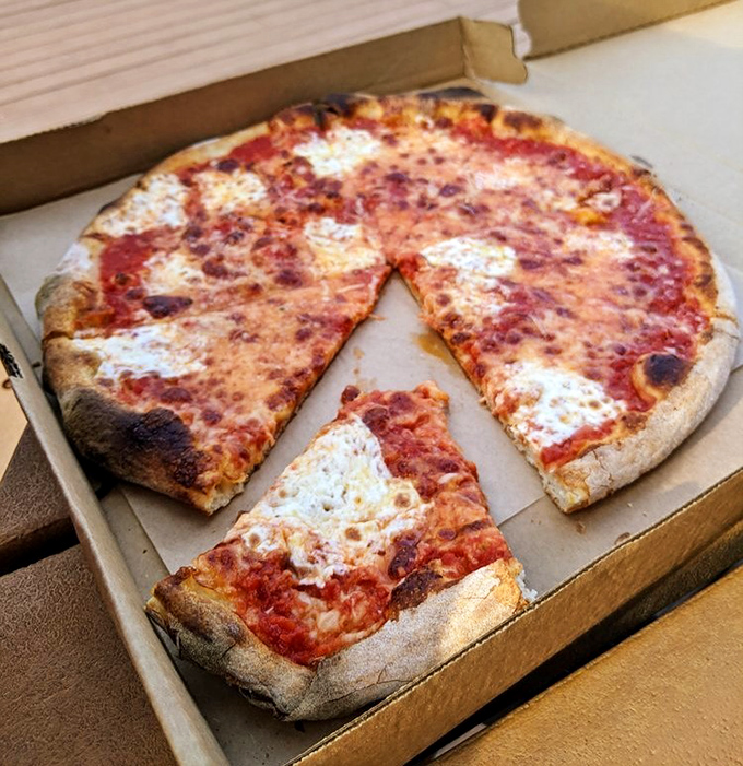 The Margherita pizza in its takeout box&mdash;proof that even when traveling, Beddia's magic remains intact, ready to transform your kitchen table.