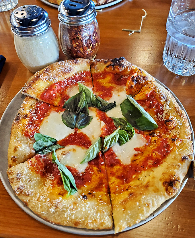 The Margherita pizza arrives like a work of art&mdash;charred crust, vibrant sauce, melty cheese, and basil leaves playing their perfect supporting roles.