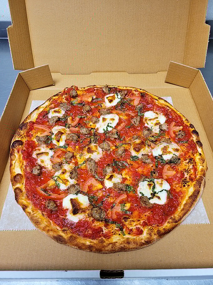 Sausage and fresh mozzarella on a perfect crust &ndash; proof that sometimes the simplest combinations create the most profound happiness.