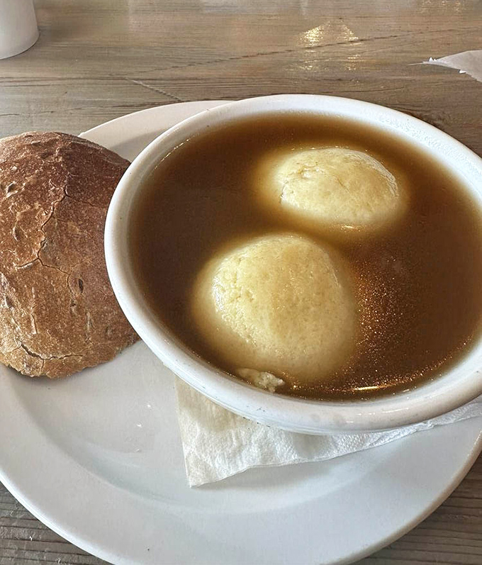 Matzo ball soup so comforting it could end international conflicts. Those fluffy dumplings floating in golden broth are edible therapy.