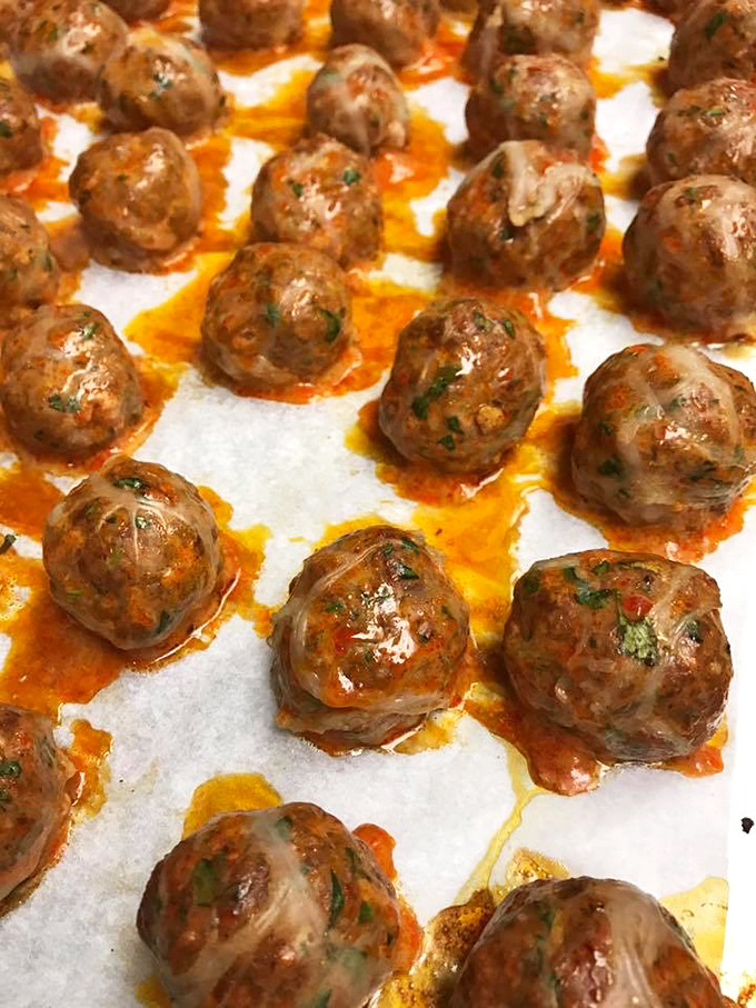 These aren't just meatballs; they're little orbs of herby, savory perfection waiting to join the sauce-and-cheese dance party.