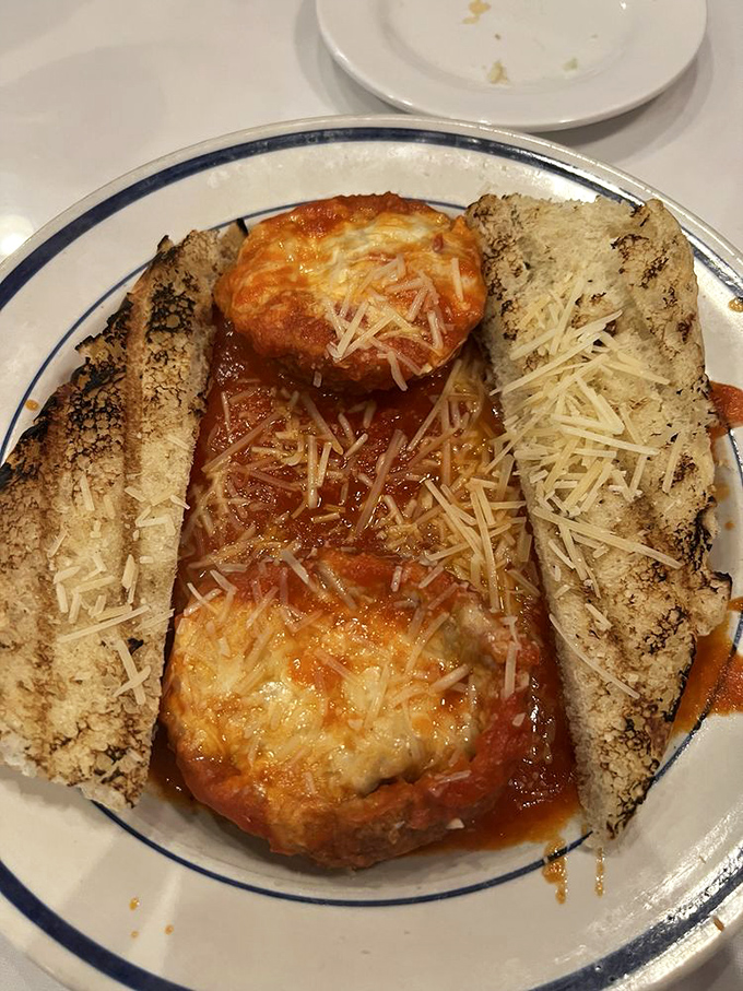 Not just any meatball – a proper Italian masterpiece surrounded by garlic bread that's worth every carb-laden bite.