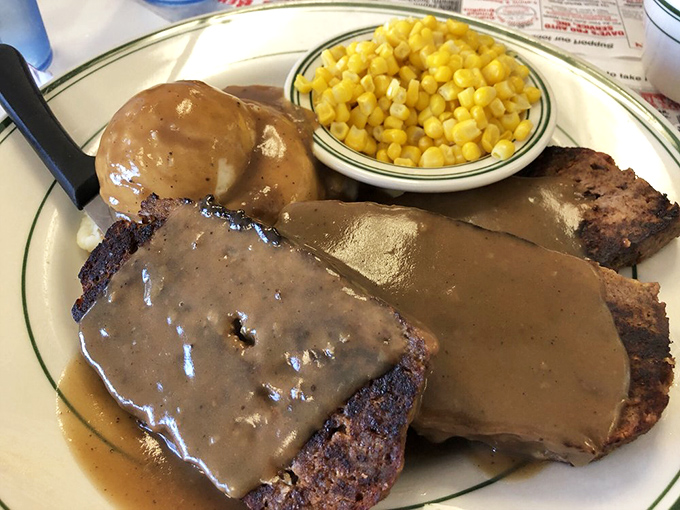 Meatloaf swimming in gravy with a side of sweet corn&mdash;the kind of plate that makes you want to call your mother and apologize.