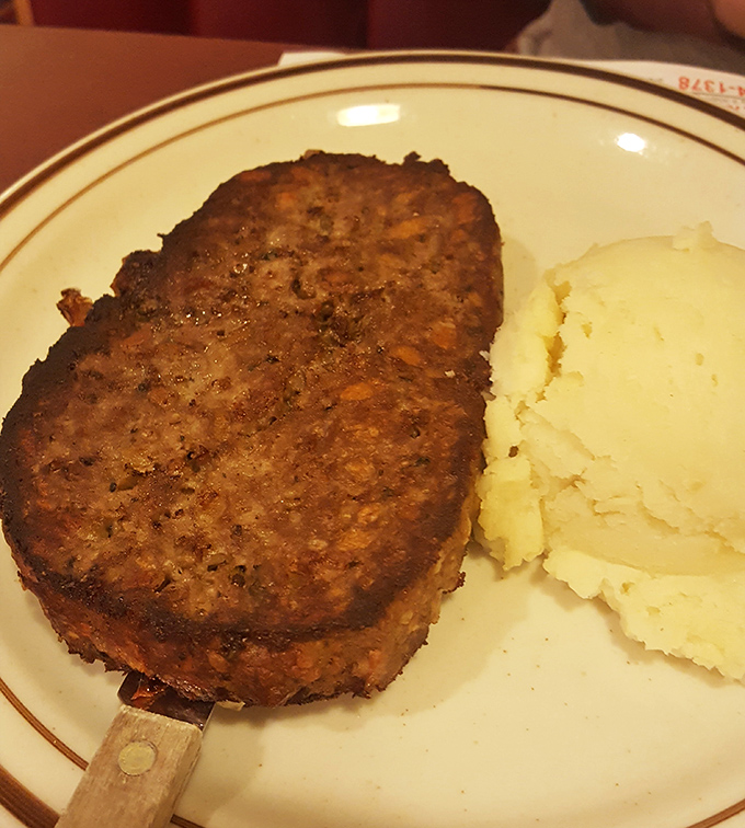 Meatloaf that would make your grandmother both proud and jealous, paired with cloud-like mashed potatoes. Comfort food royalty on a simple plate.