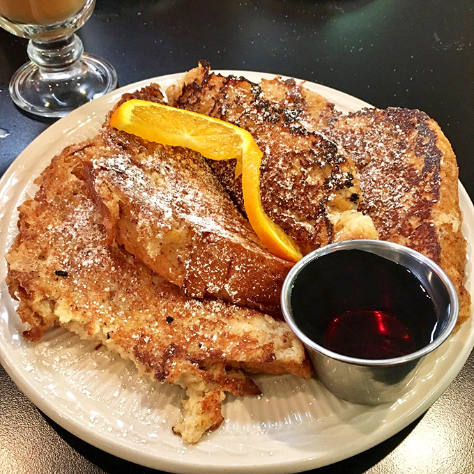 French toast that dressed up for the occasion, dusted with powdered sugar and accessorized with a citrus slice. Breakfast or dessert? Yes.