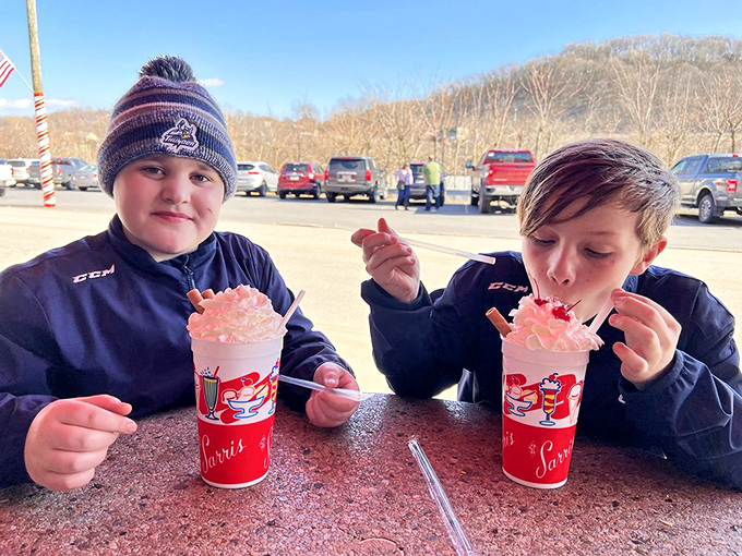 Two young chocolate commandos plotting their next sweet move. Those milkshakes aren't just drinks &ndash; they're childhood memories in a cup.