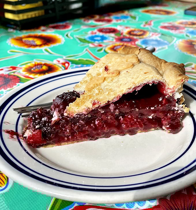 This mixed berry pie isn't just dessert; it's summer captured in a flaky crust, with berries doing their best impression of edible jewels.