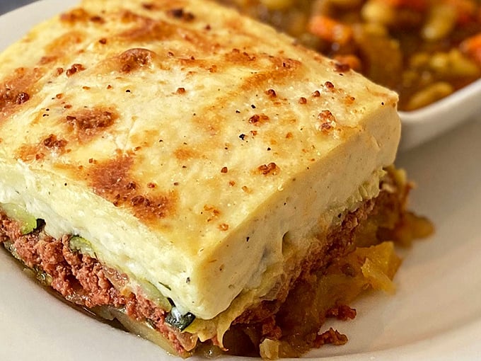 Moussaka: where comfort food meets culinary art. That golden b&eacute;chamel crust is hiding layers of flavor that'll make you forget about lasagna forever.