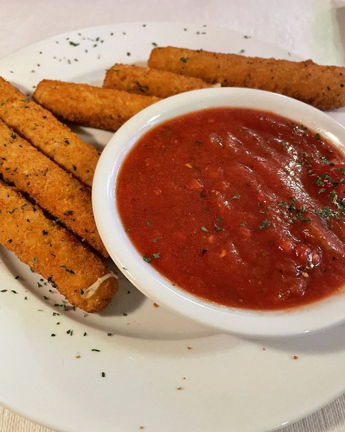 These aren't just mozzarella sticks&mdash;they're crispy golden vessels delivering molten cheese to your soul, with marinara as their trusty sidekick.