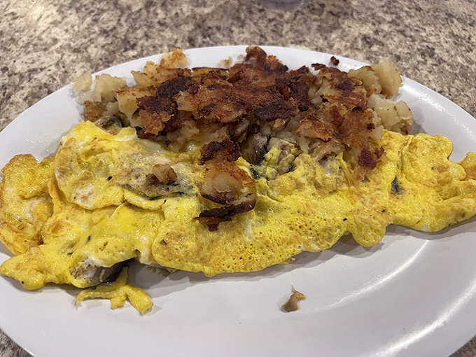 An omelette that's achieved the perfect golden hue, with home fries that could make a potato farmer weep with pride.