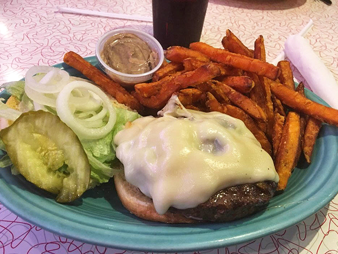A burger that requires both hands and several napkins is always a good sign. Those sweet potato fries look like they're auditioning for a supporting actor award.