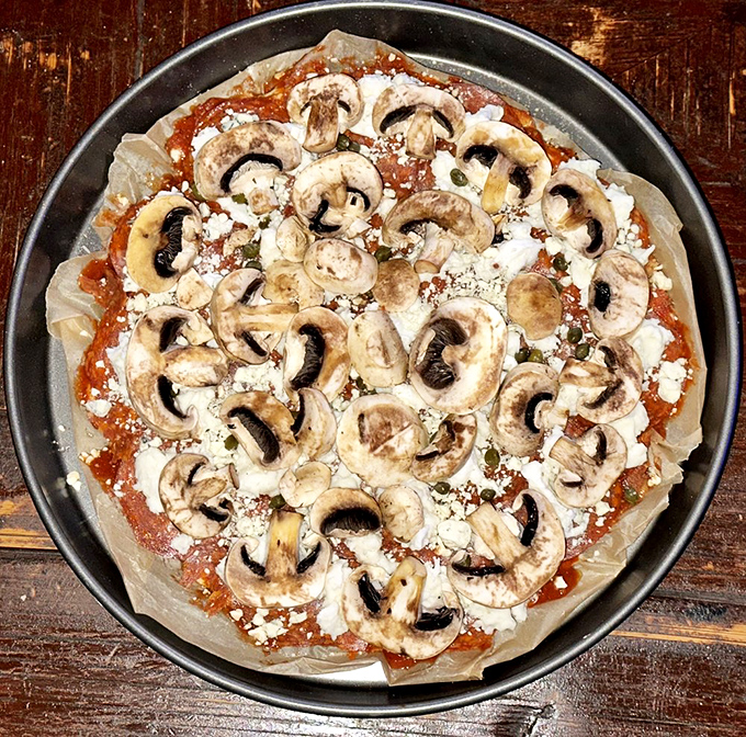 This mushroom pizza isn't trying to be trendy; it's just confidently being delicious while the food fads come and go around it.