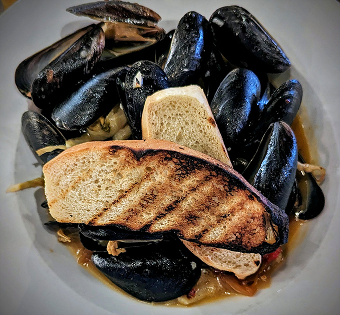 These mussels aren't just dinner, they're a maritime adventure &ndash; plump treasures bathed in a broth so good you'll be plotting ways to drink it discreetly.