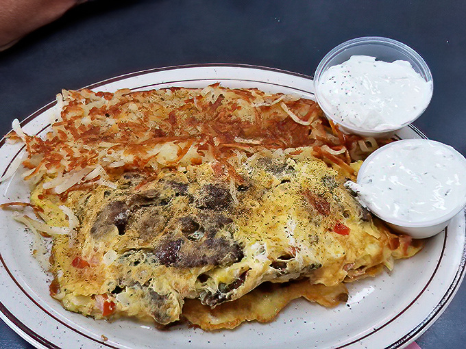 An omelet that doesn't just sit on the plate&mdash;it commands attention with its perfectly browned exterior hiding treasures within.
