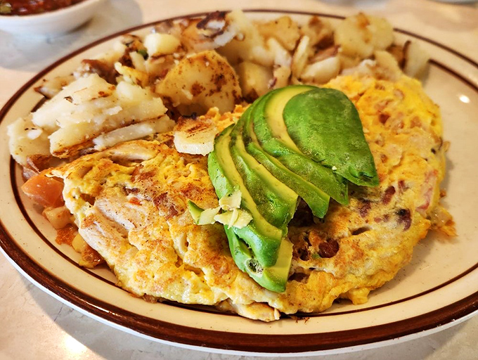This omelet doesn't just have avocado—it wears it like a crown. A fluffy testament to the fact that breakfast is the most important art form of the day.