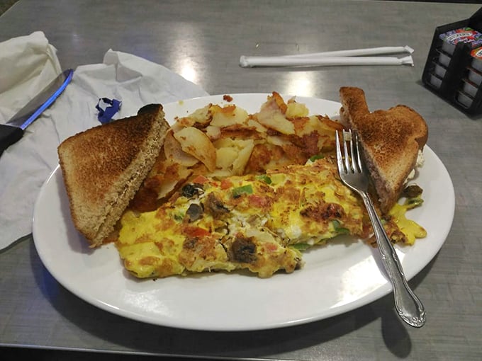 Breakfast artistry in action&mdash;this veggie-packed omelet with perfectly golden home fries proves morning meals deserve serious culinary respect.