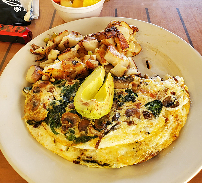 An omelet stuffed with spinach and mushrooms alongside golden home fries. Vegetables never had it so good in the breakfast world. 