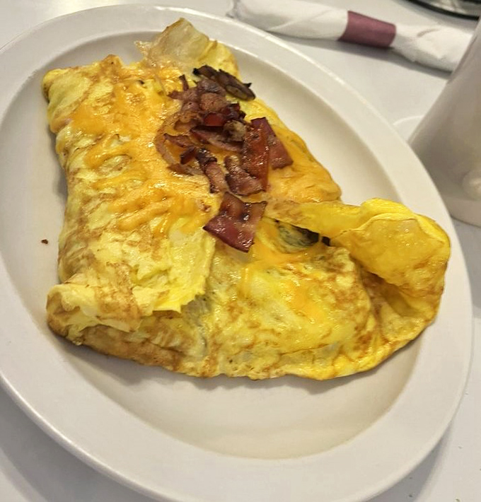 The omelet that launched a thousand detours—cheese perfectly melted, bacon crispy, eggs fluffy as morning clouds.