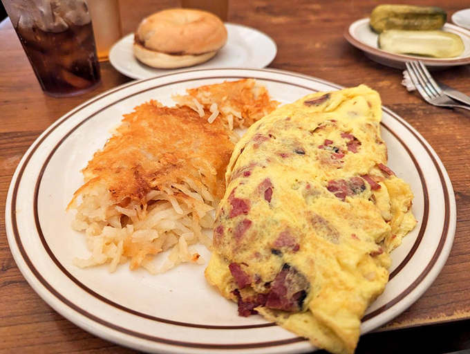 Breakfast served all day because time is a construct, but hunger is real. This corned beef hash omelet doesn't care what your watch says.