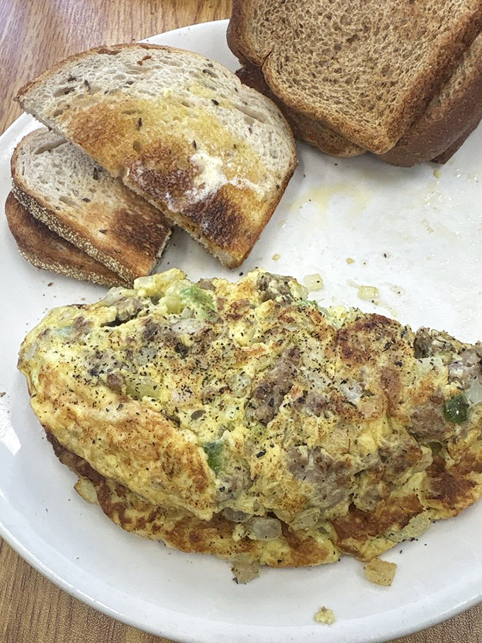 This herb-flecked omelet showcases the kitchen's mastery of eggs, folded to golden perfection with care.