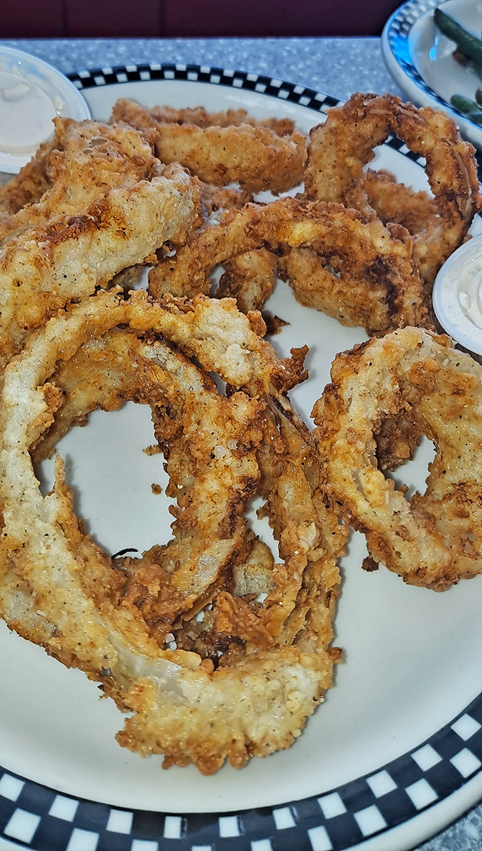 Onion rings so perfectly golden and crispy, they deserve their own trophy. The dipping sauce is just showing off at this point.