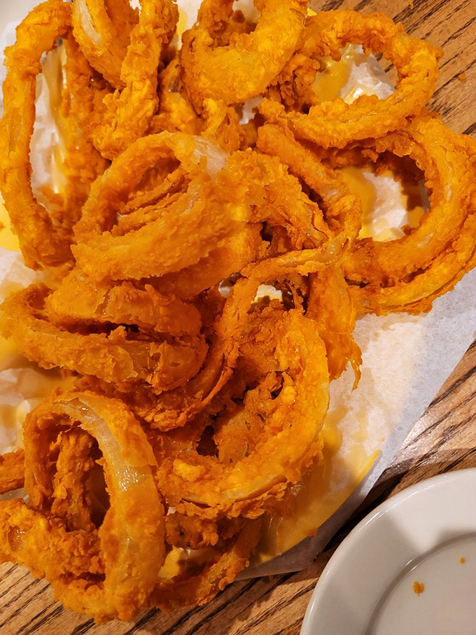 Onion rings so magnificently golden they look like edible halos sent straight from fried food heaven.