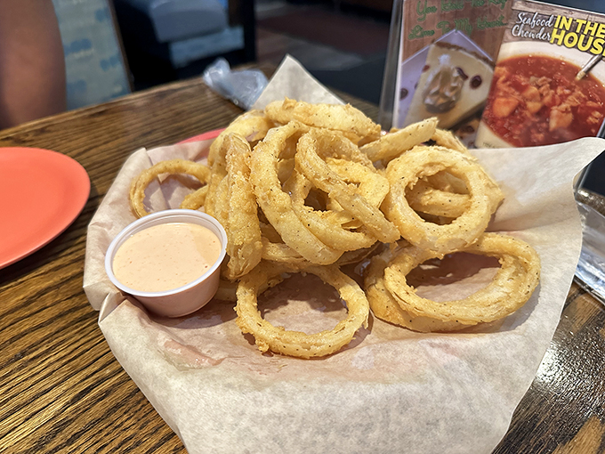 Onion rings with the structural integrity of Olympic gold medals. Crispy, light, and begging to be dunked in that creamy sauce.