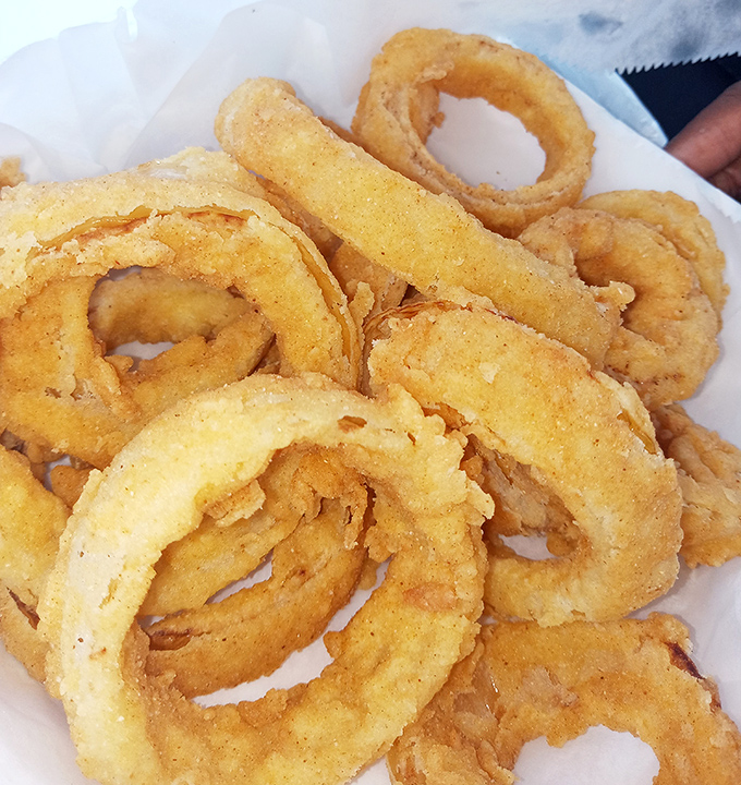 These aren't just onion rings &ndash; they're golden halos of happiness. The kind of crispy perfection that makes you forget you're technically eating a vegetable.