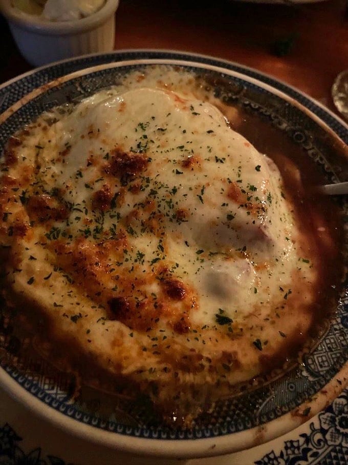 French onion soup wearing its cheese beret with such confidence, it practically whispers "oui oui" with every steaming spoonful.