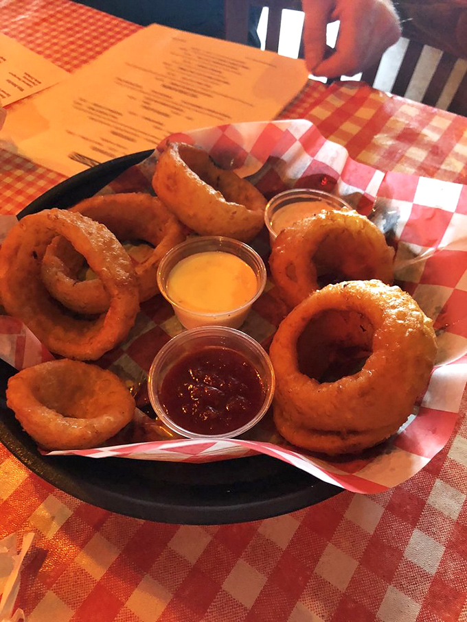 Onion rings with the perfect crunch-to-softness ratio, served with dipping sauces that make you forget you're essentially eating a vegetable.