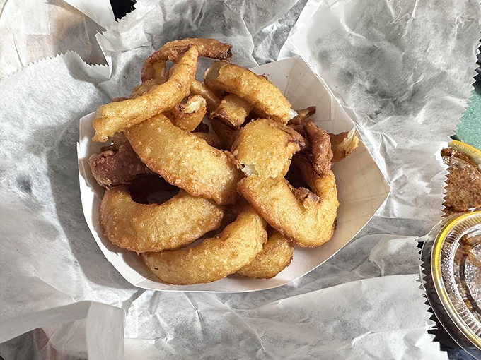 Onion rings with the structural integrity of Olympic medals. Each golden hoop promises a satisfying crunch that echoes through the decades.