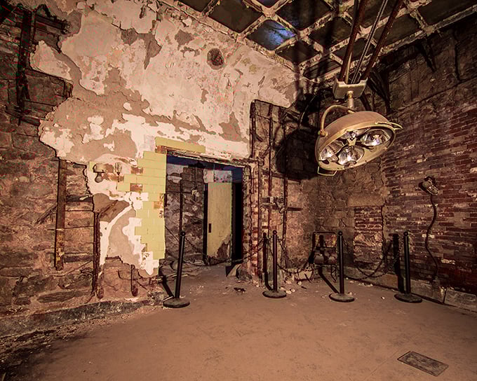 The prison's medical facilities look more "horror film" than "healing center." That overhead lamp has witnessed procedures best left to imagination.