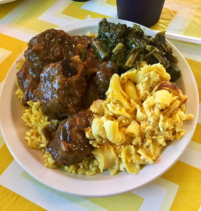 Oxtails, collard greens, and mac and cheese—the holy trinity of soul food. This plate isn't just a meal; it's generations of culinary wisdom on display.