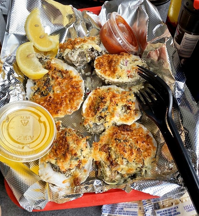 Oysters Rockefeller on foil &ndash; unpretentious presentation for a dish that lets the briny-sweet flavors take center stage.